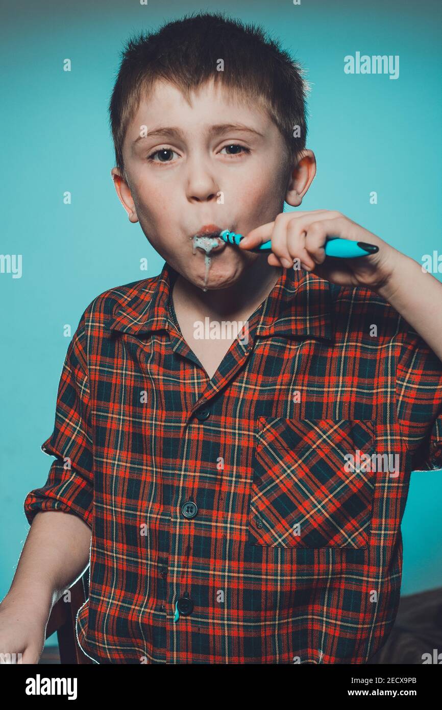 Handsome boy brushing teeth, daily procedure, baby in pajamas, dental ...