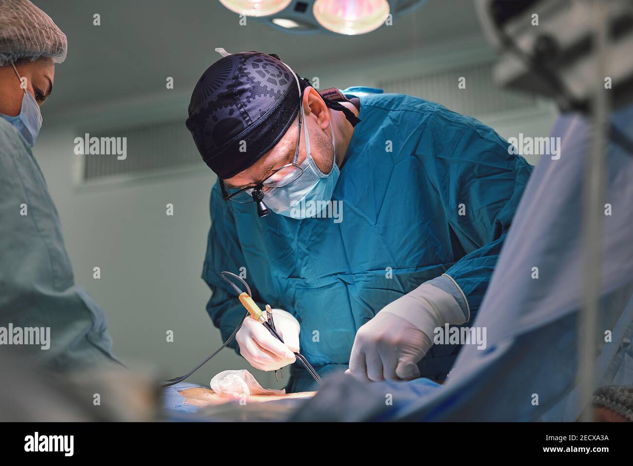 surgeon during liposuction in the operating room Stock Photo - Alamy