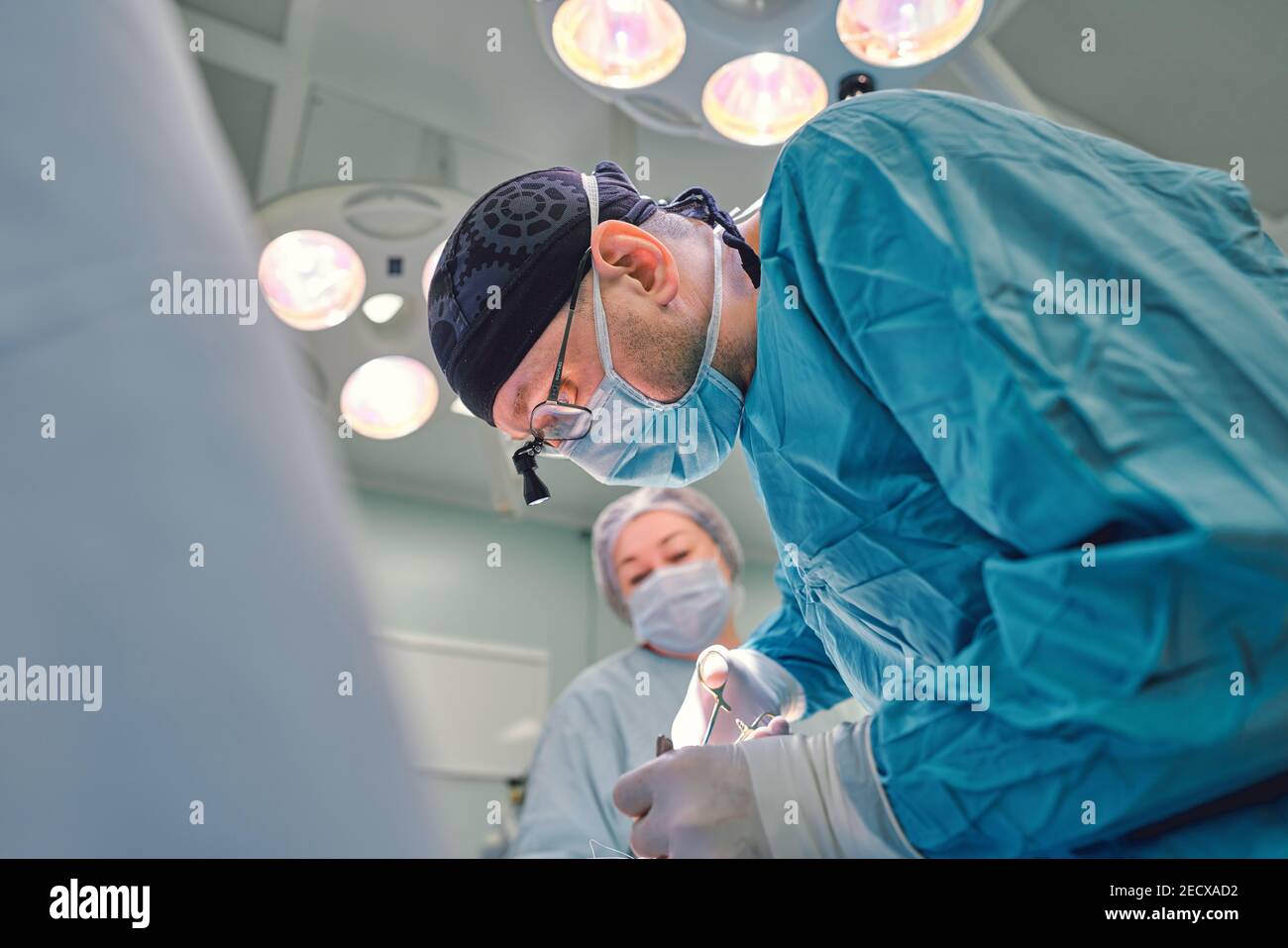 surgeon during liposuction in the operating room Stock Photo - Alamy
