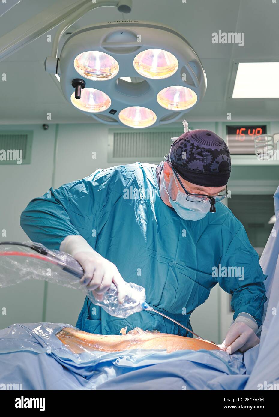 surgeon during liposuction in the operating room Stock Photo - Alamy