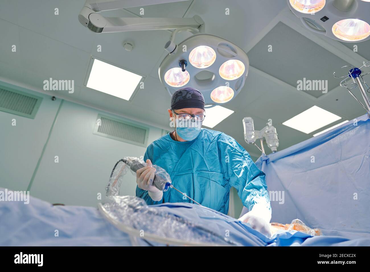 surgeon during liposuction in the operating room Stock Photo - Alamy