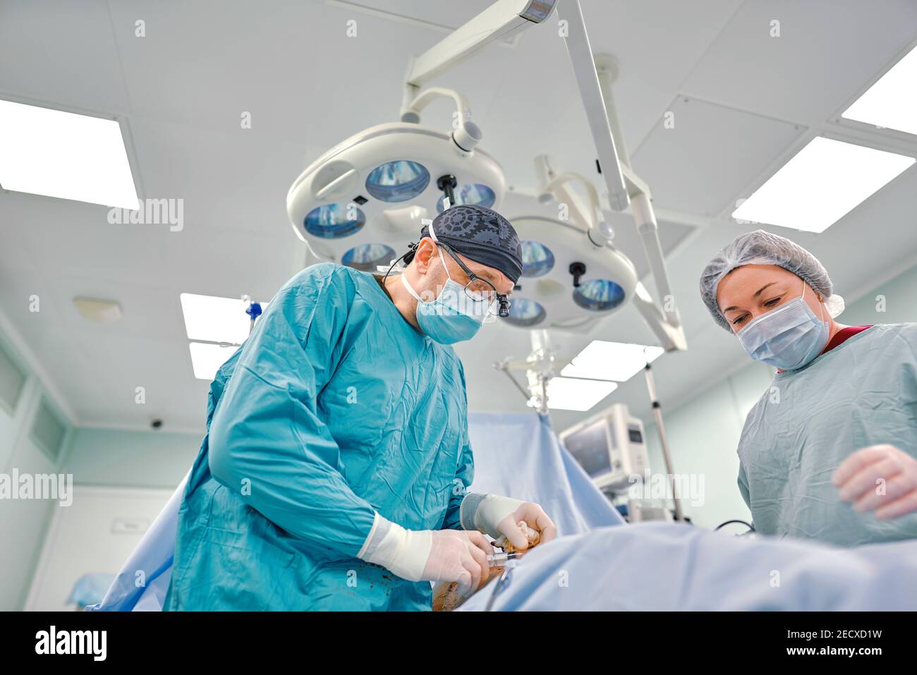 surgeon during liposuction in the operating room Stock Photo - Alamy