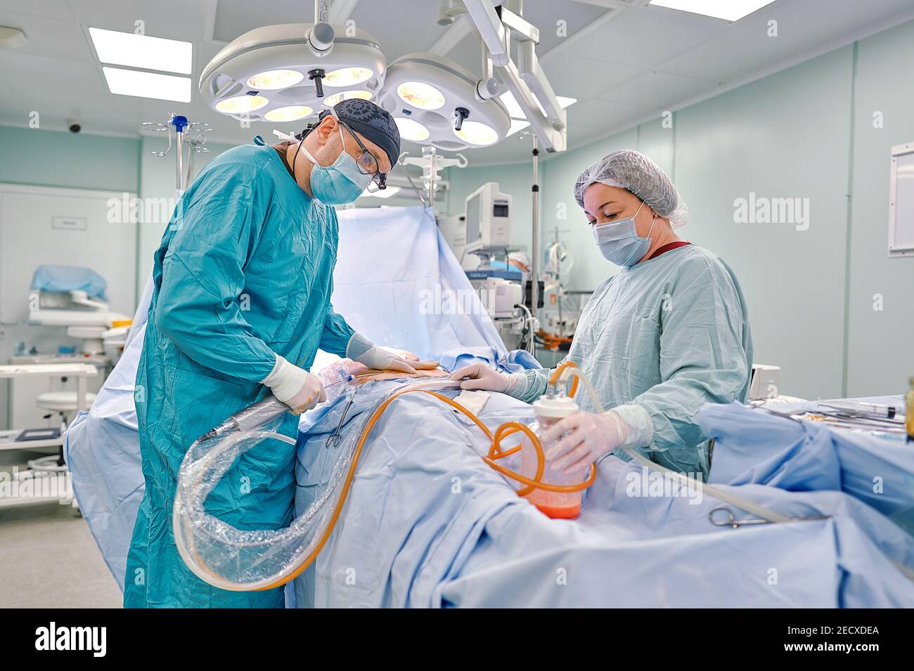 surgeon during liposuction in the operating room Stock Photo - Alamy