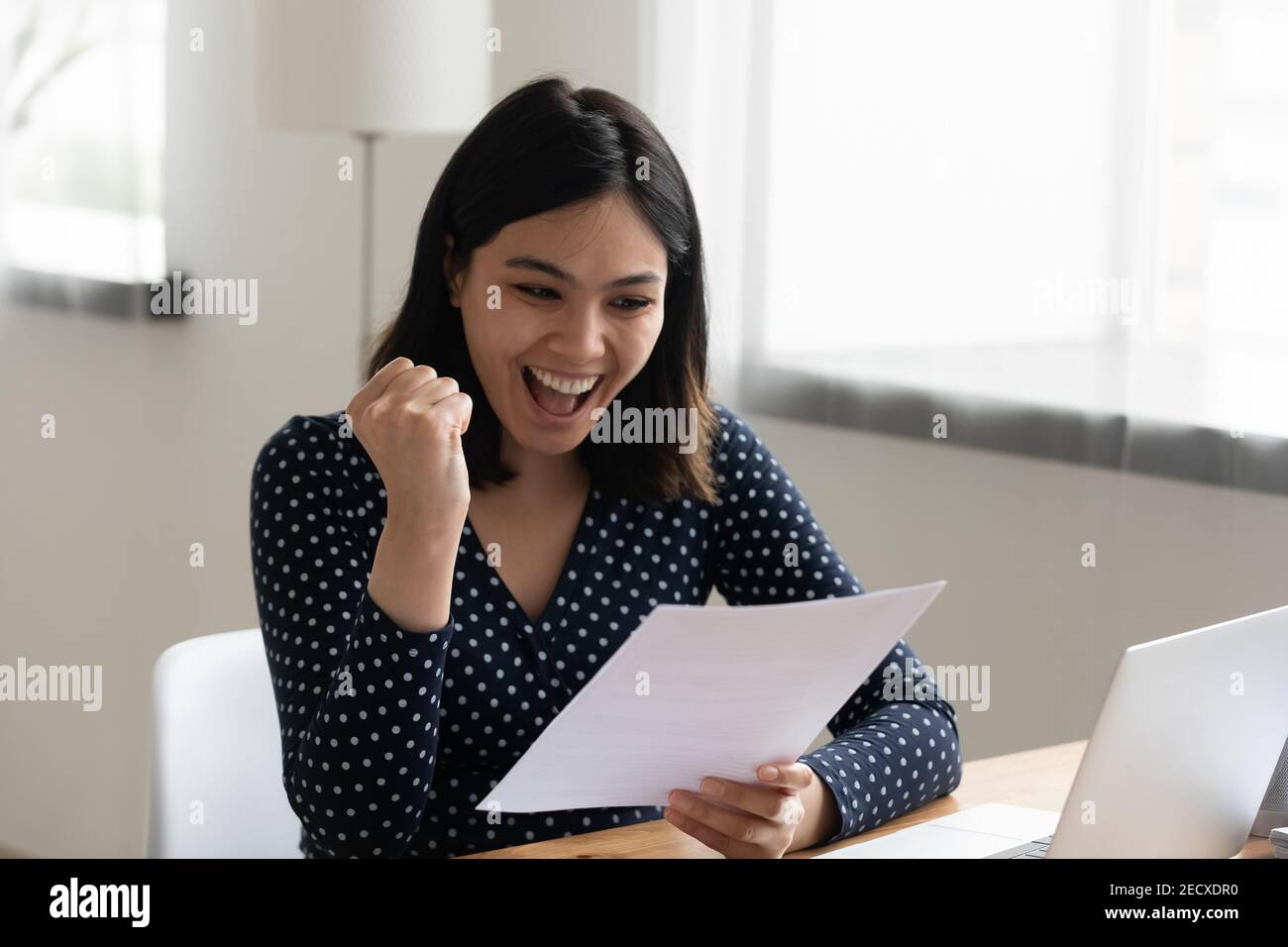 Amazed asian female student hold letter with good test results Stock ...