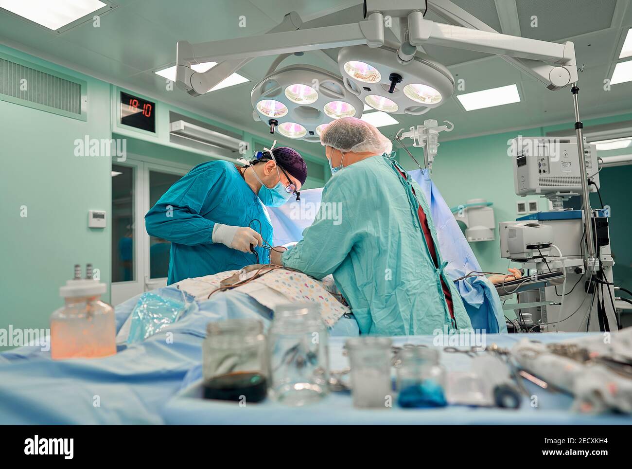 Team surgeons are performing an operation, handsome middle aged doctor ...