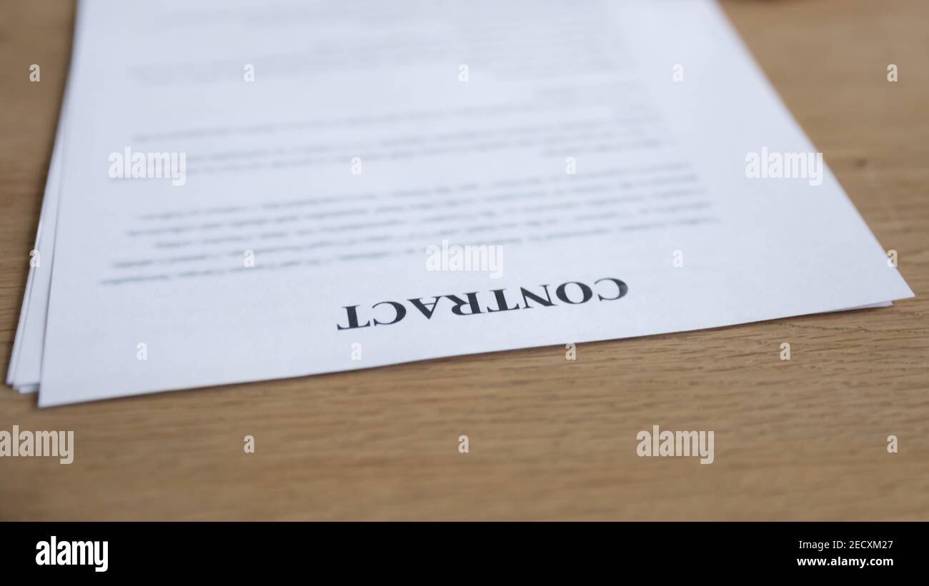 Close up of paper contract on office table Stock Photo - Alamy