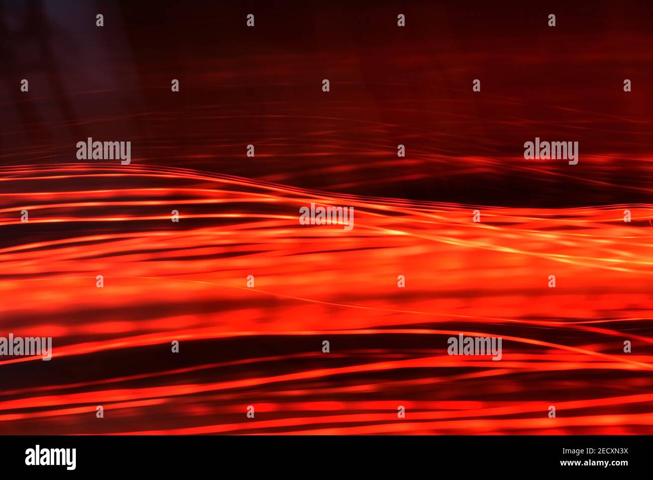 Abstract background of red neon glowing light shapes. Bright stripes ...