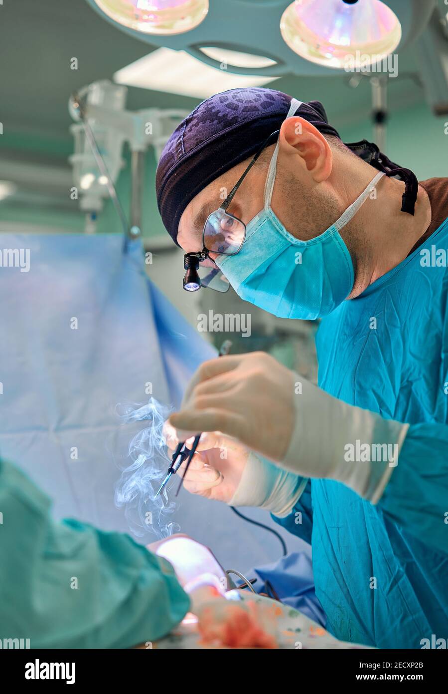 Team surgeons are performing an operation, handsome middle aged doctor ...