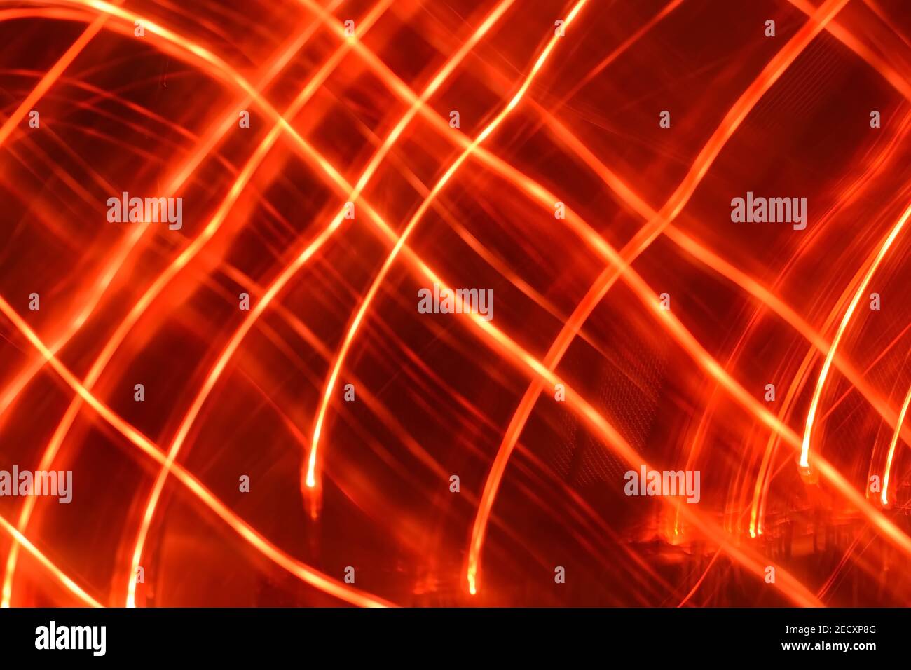 Abstract background of red neon glowing light shapes. Bright stripes ...