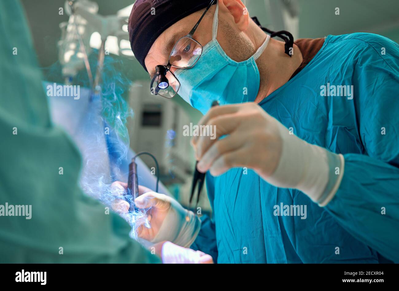 Team surgeons are performing an operation, handsome middle aged doctor ...