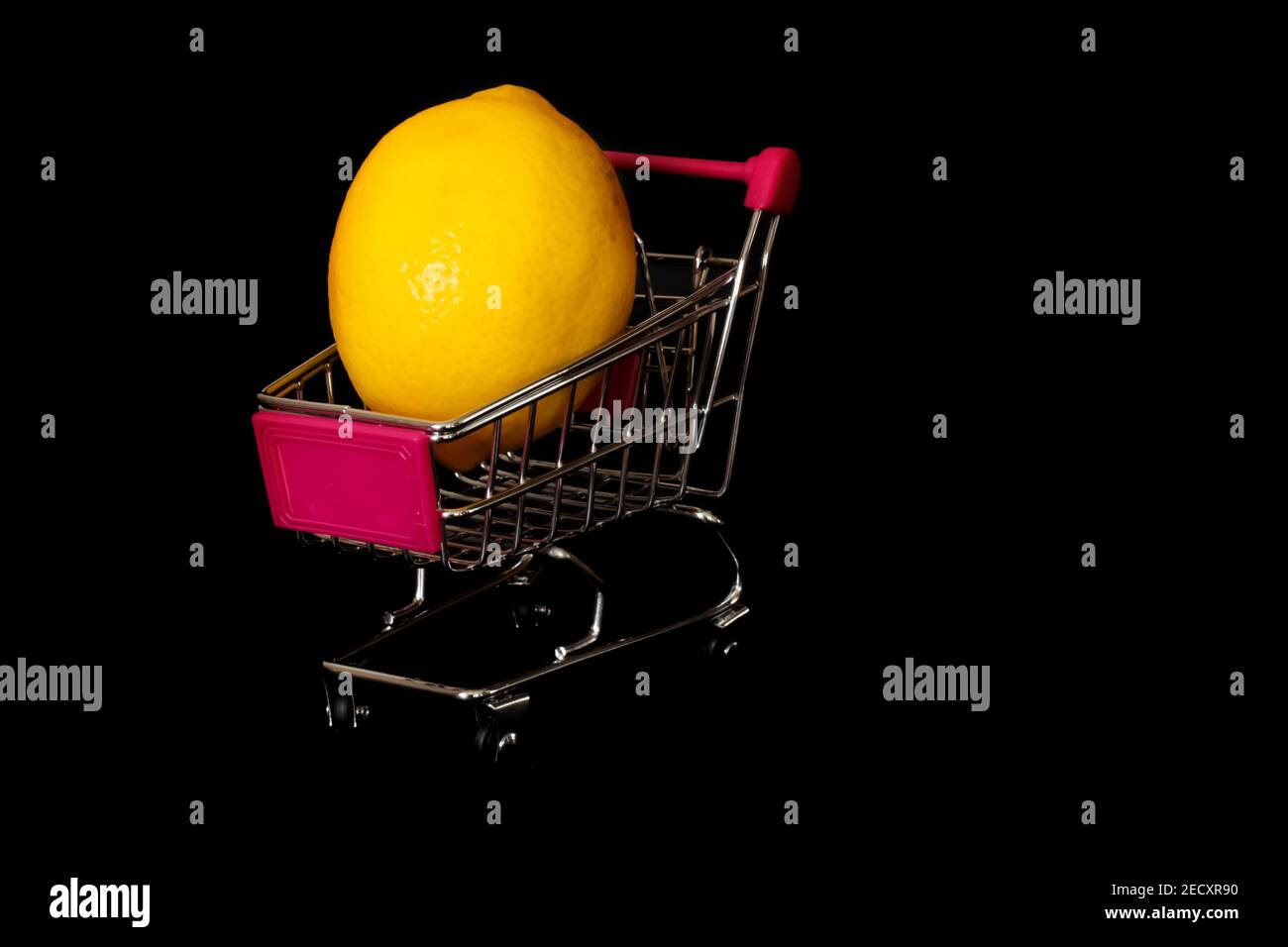 Fresh organic lemon in a mini shopping cart or trolley. Isolated on ...