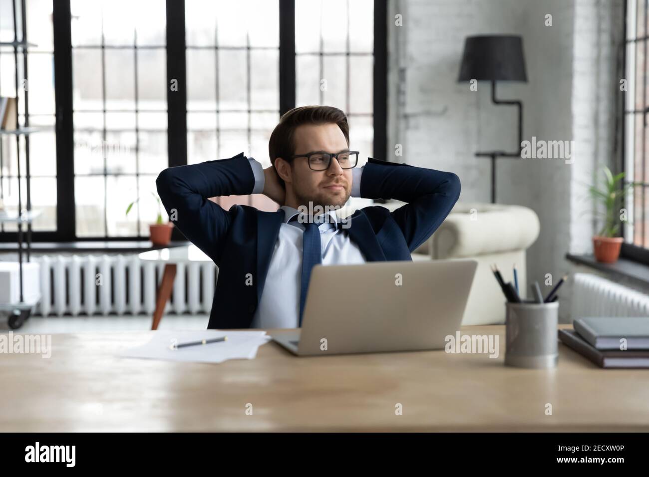 Happy male CEO relax in office making plans Stock Photo - Alamy