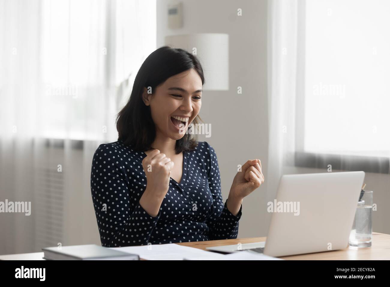 Overjoyed asian lady office worker get reward promotion by email Stock ...