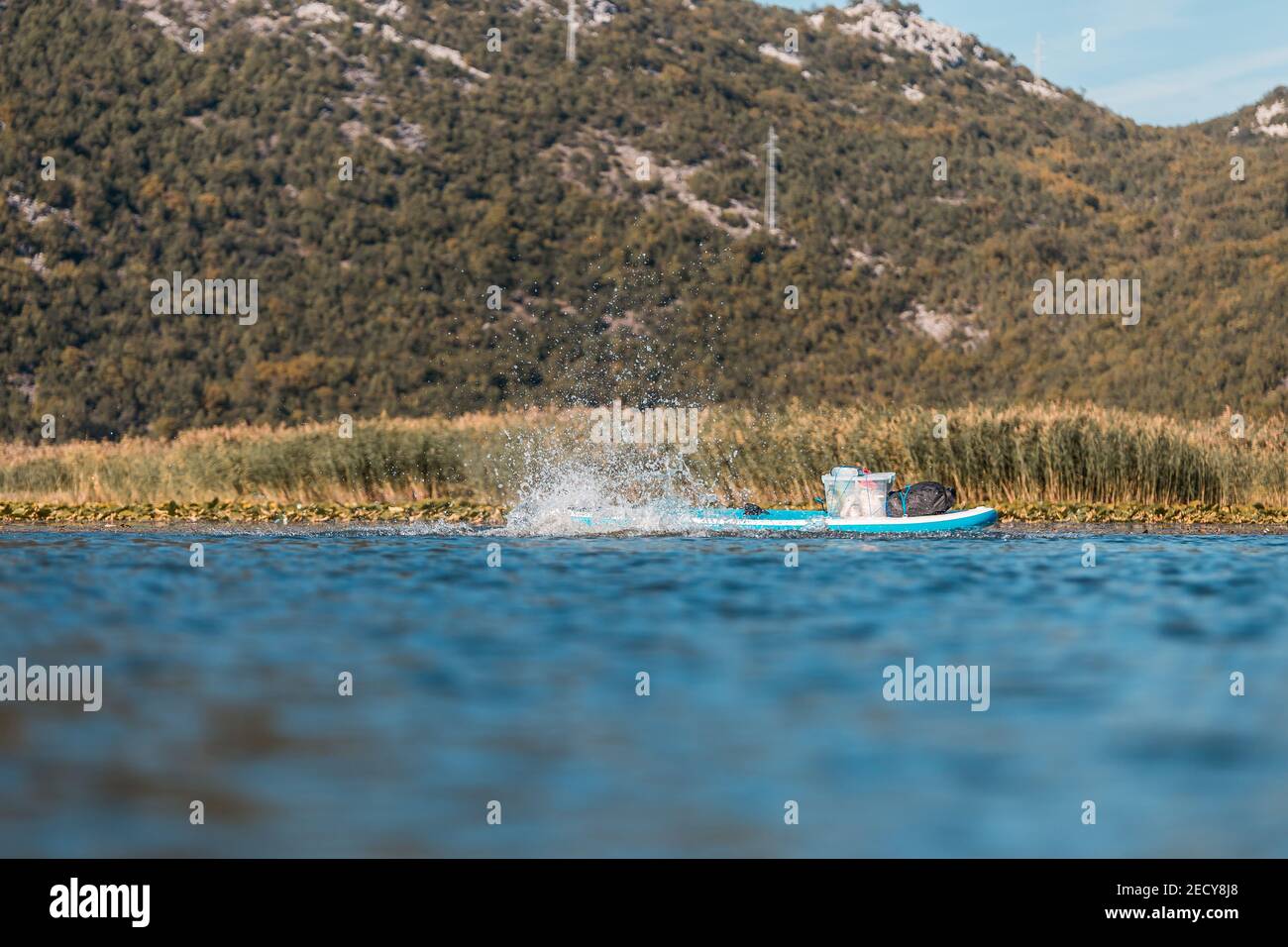 A SUP paddleboard in the river with water splash Stock Photo - Alamy
