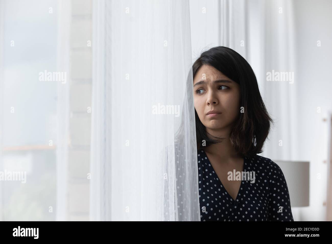 Sad young asian woman stand by window think of loneliness Stock Photo ...