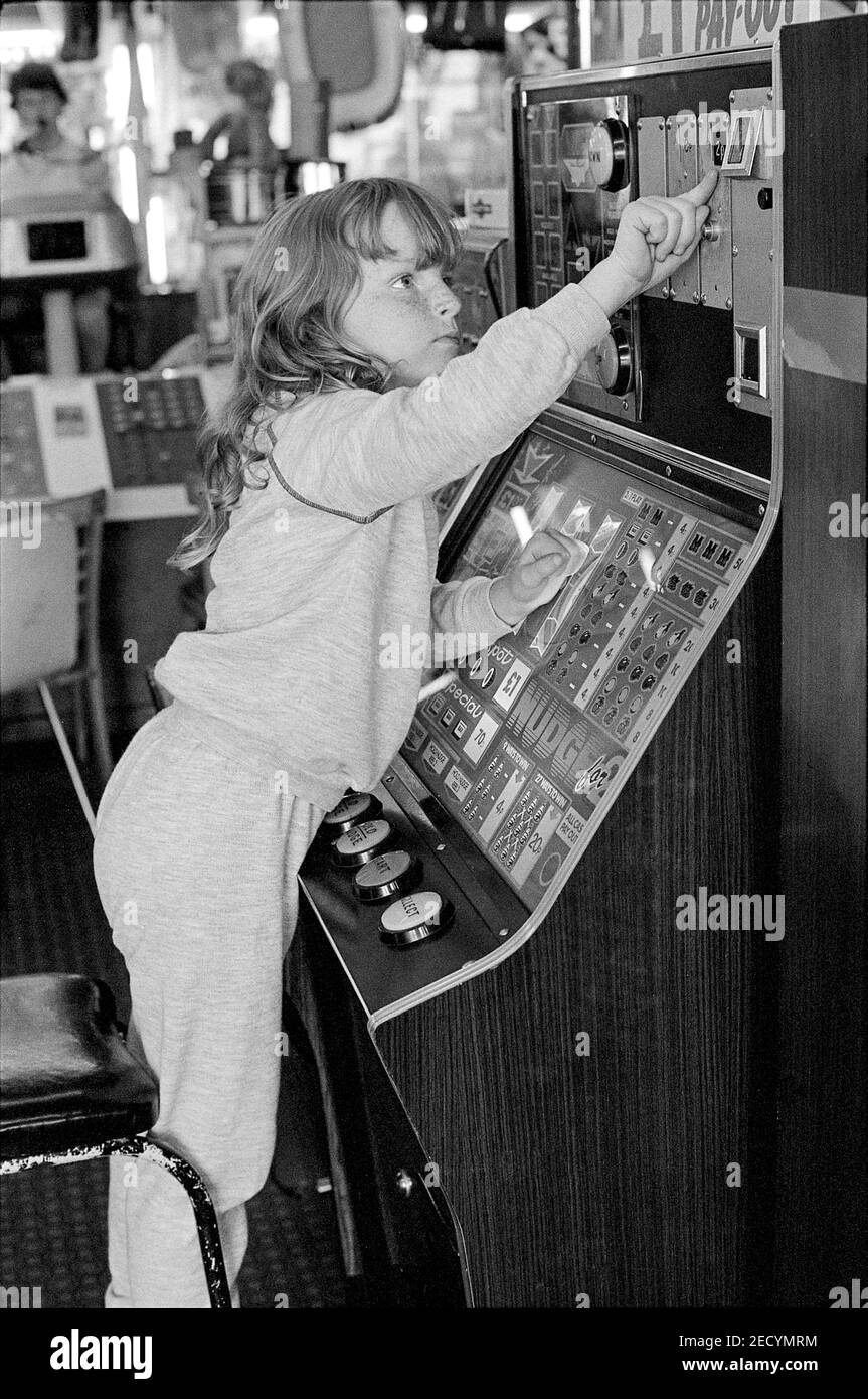 Child Playing Fruit Machine Stock Photo - Alamy