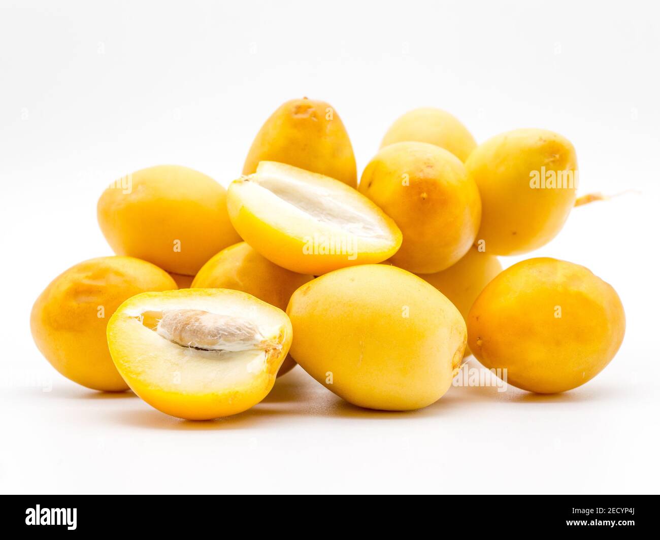 golden dates on white background Stock Photo - Alamy