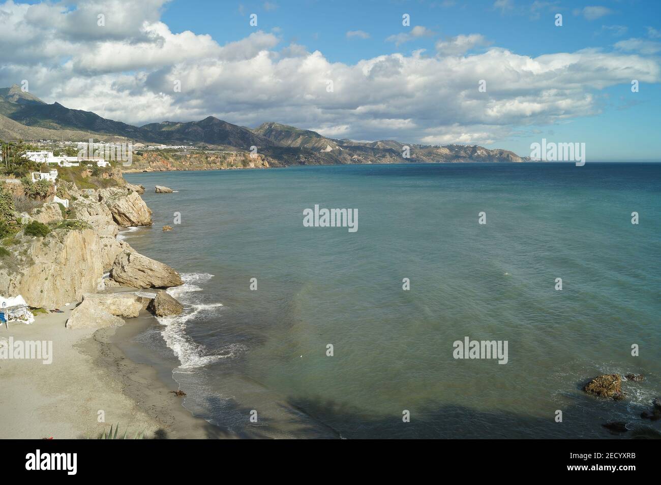 Scenic shot of the coastline at Nerja with palm trees , mountains ...
