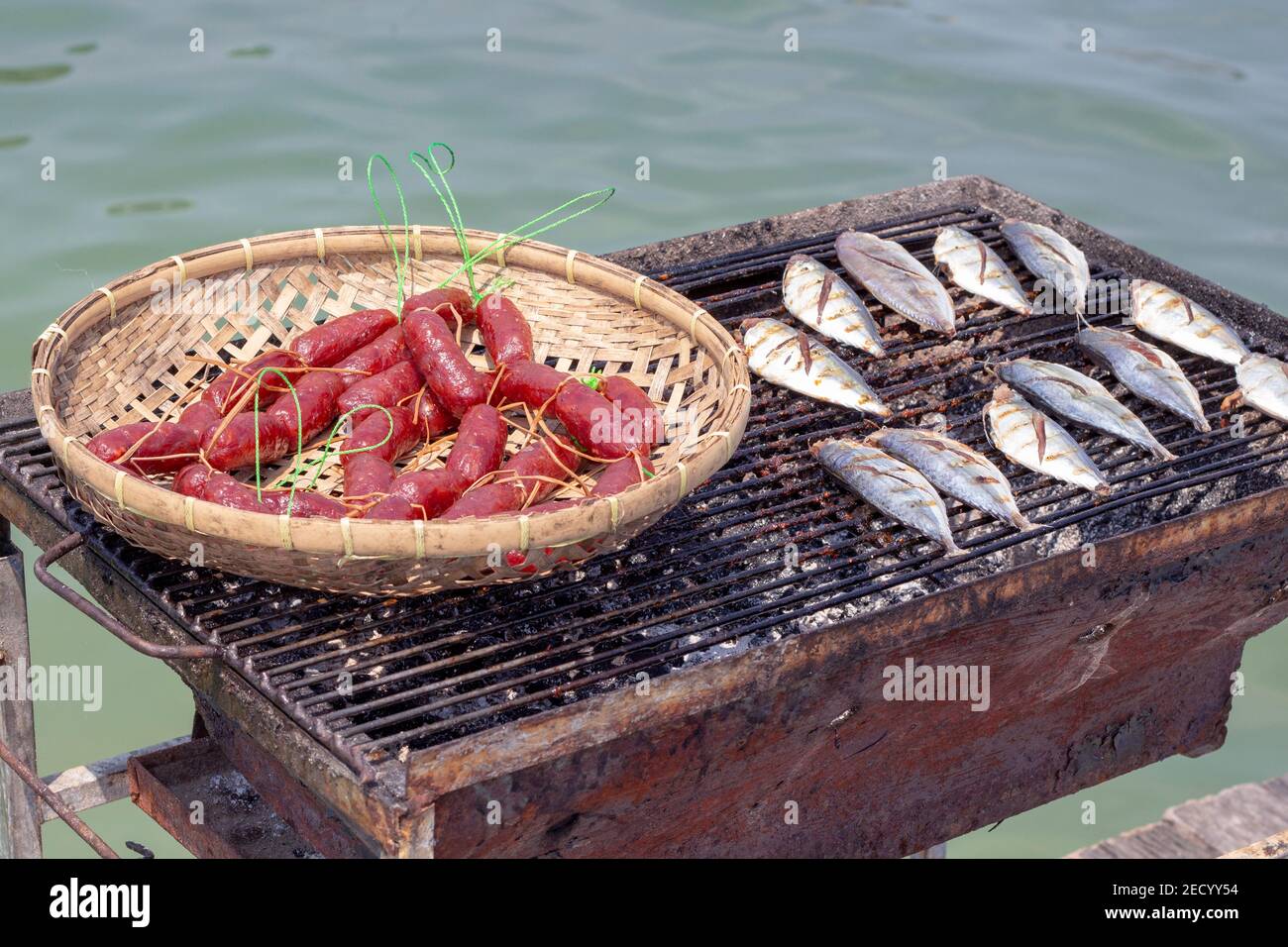 Seaside grill with saltwater fishes and pork sausages. Fish and meat ...