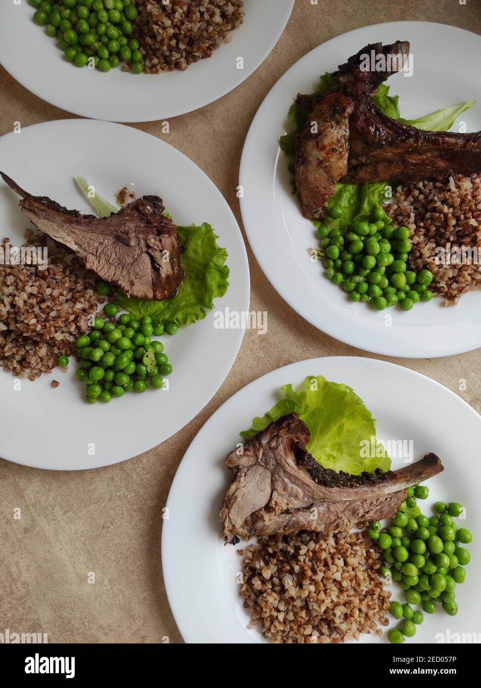 fried meat on the bone with buckwheat porridge Stock Photo - Alamy