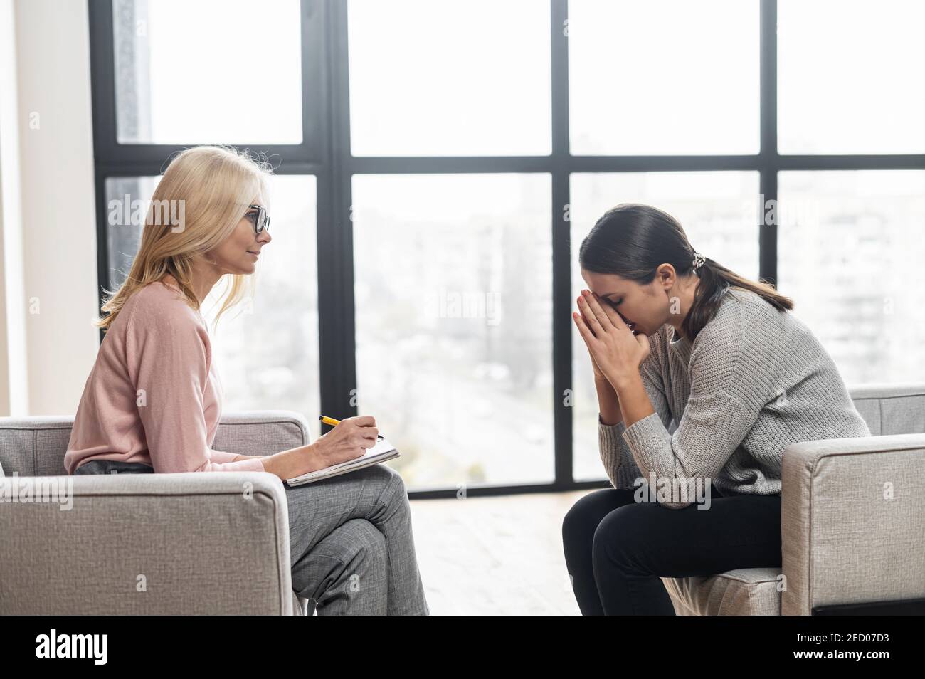 Girl at a psychologist's appointment,talking about hard period,holding ...