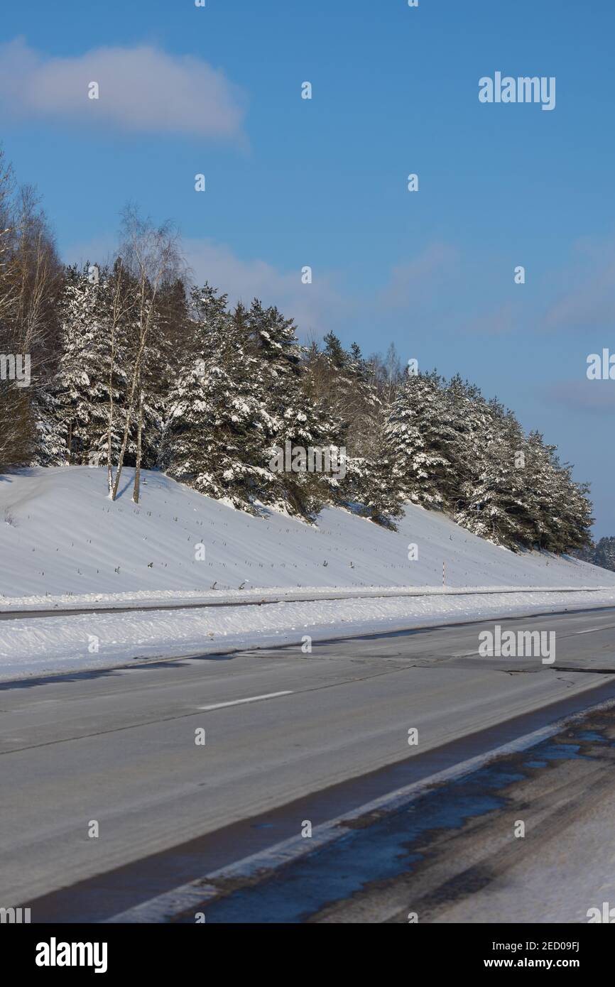 Winter landscape, road and shoulder covered with snow Stock Photo - Alamy