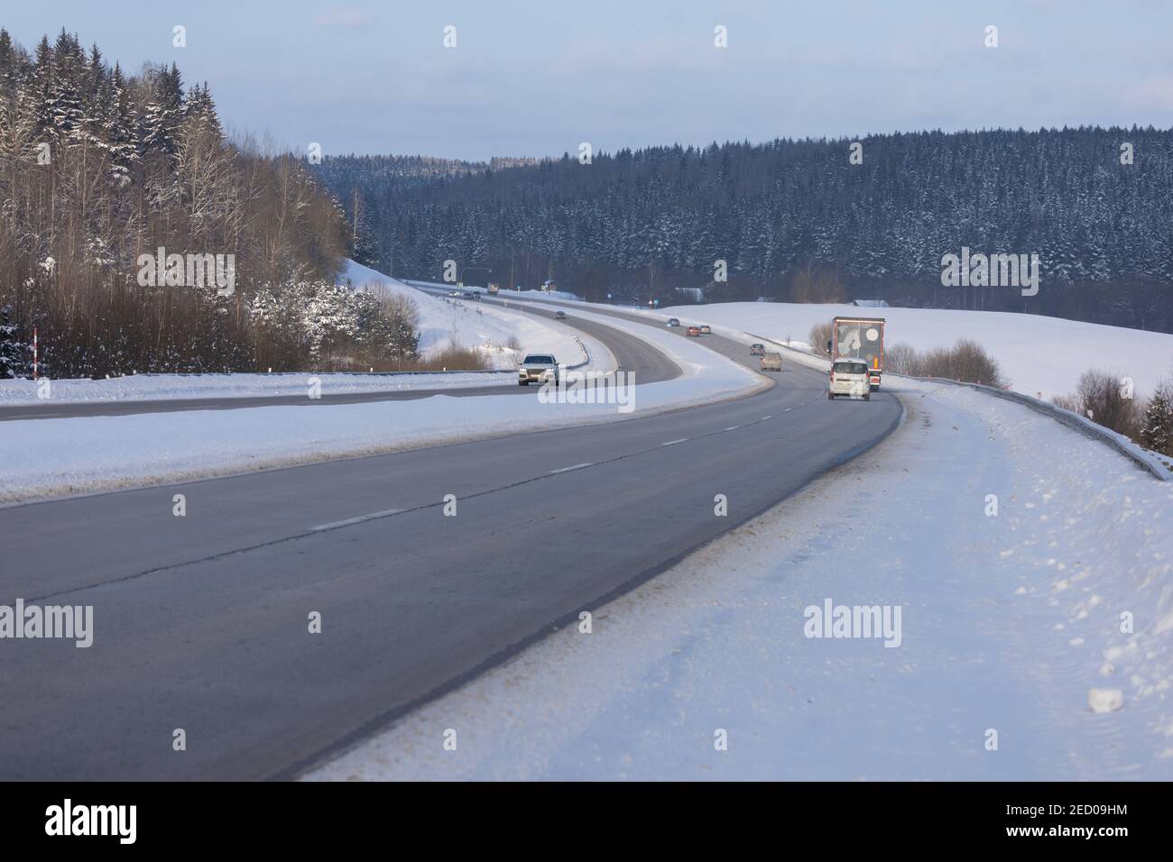 Winter road with snow, highway with cars at sunset Stock Photo - Alamy