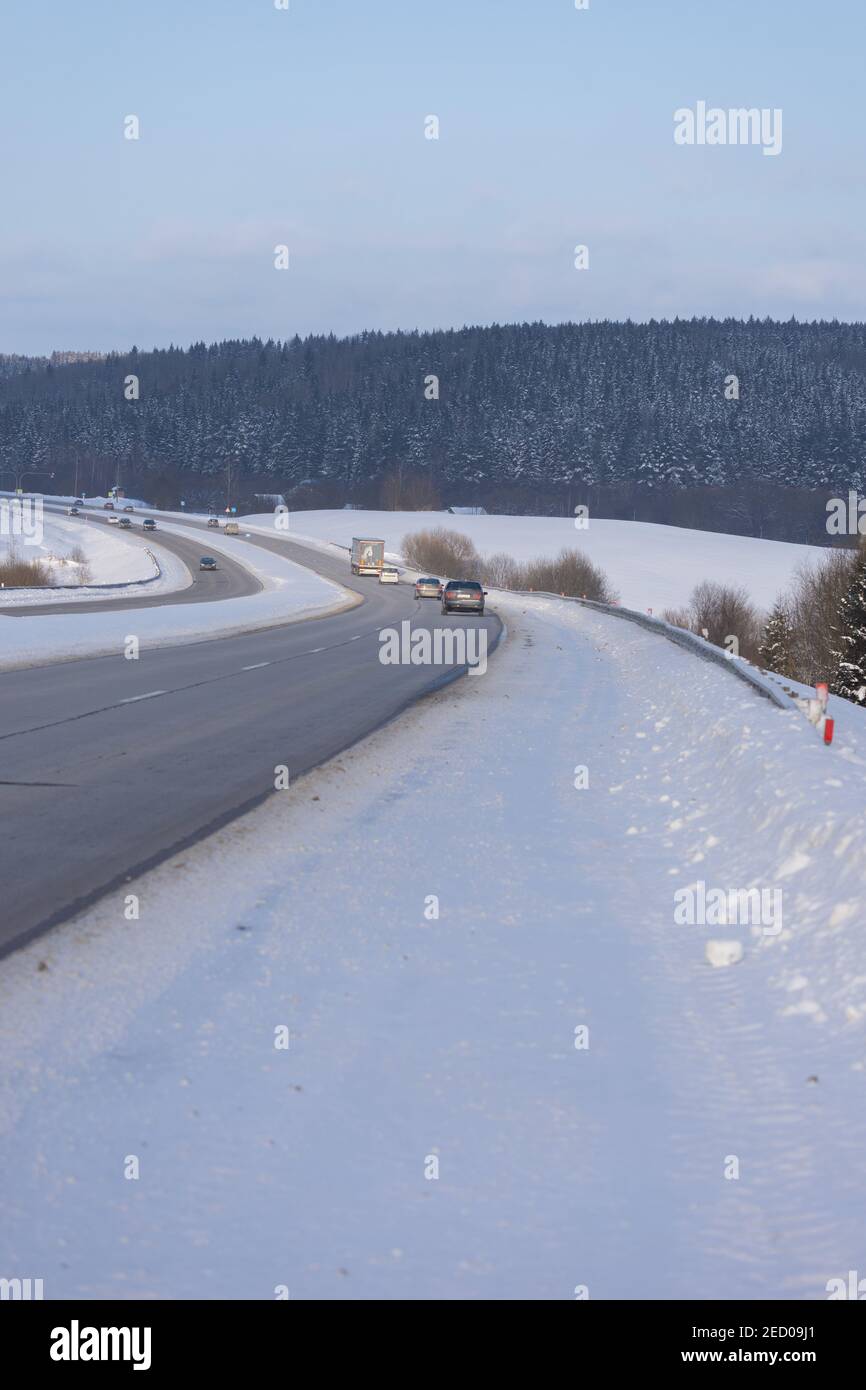 Winter road with snow, highway with cars at sunset Stock Photo - Alamy