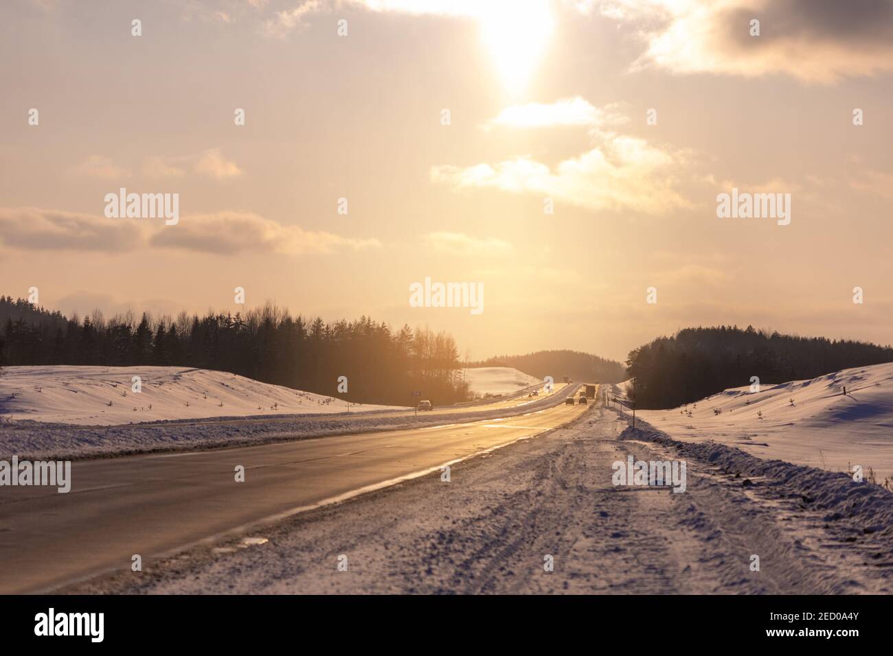 Winter road with snow, highway with cars at sunset Stock Photo - Alamy