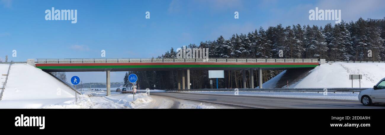 Winter road with a bridge, highway covered with snow, on a winter day ...