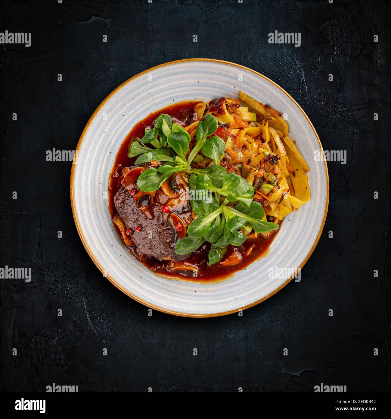 Beef meat stew with pasta on slate background. Top view Stock Photo - Alamy