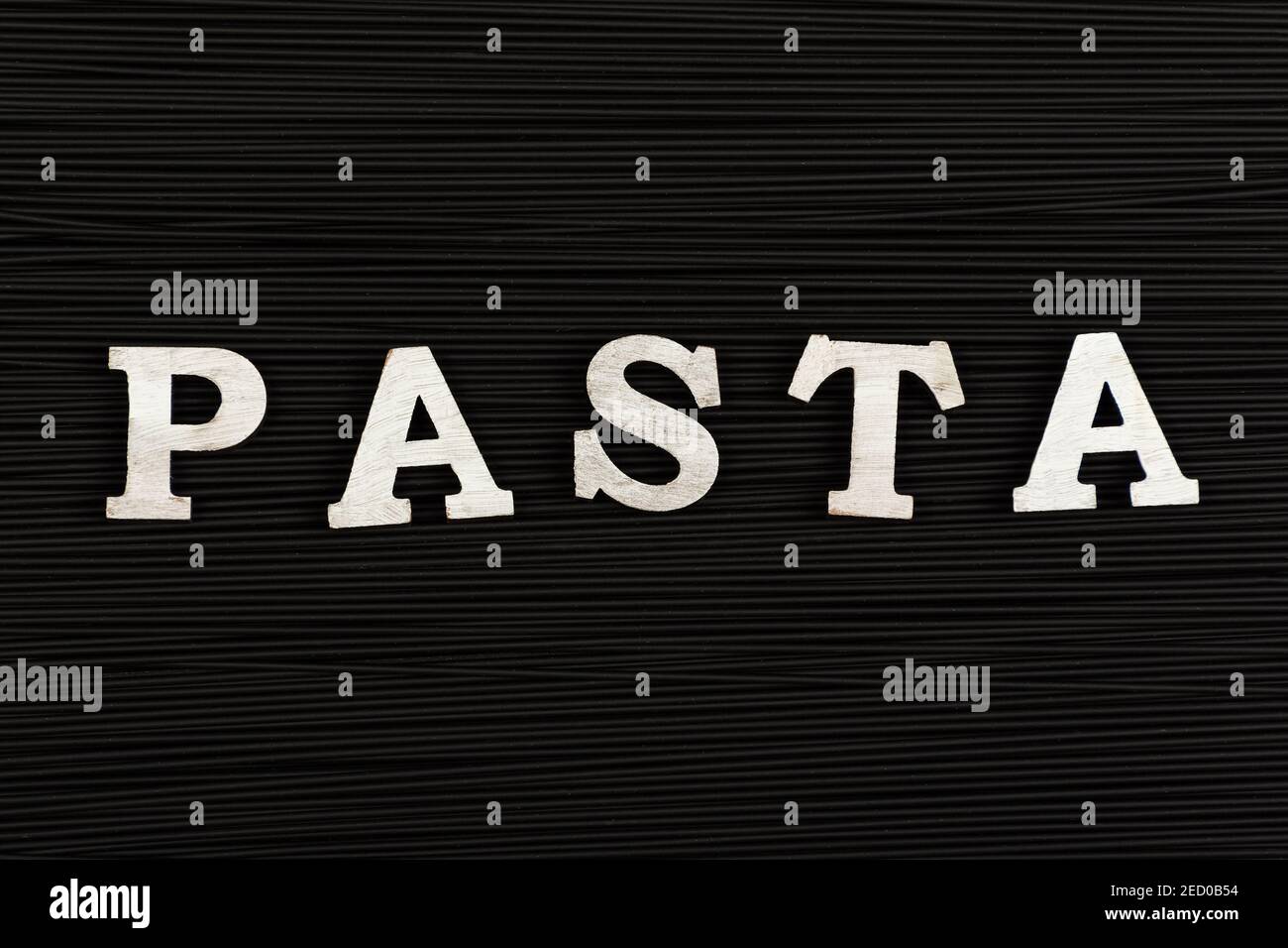 Word Pasta and uncooked black cuttlefish ink spaghetti, close up. Pasta ...