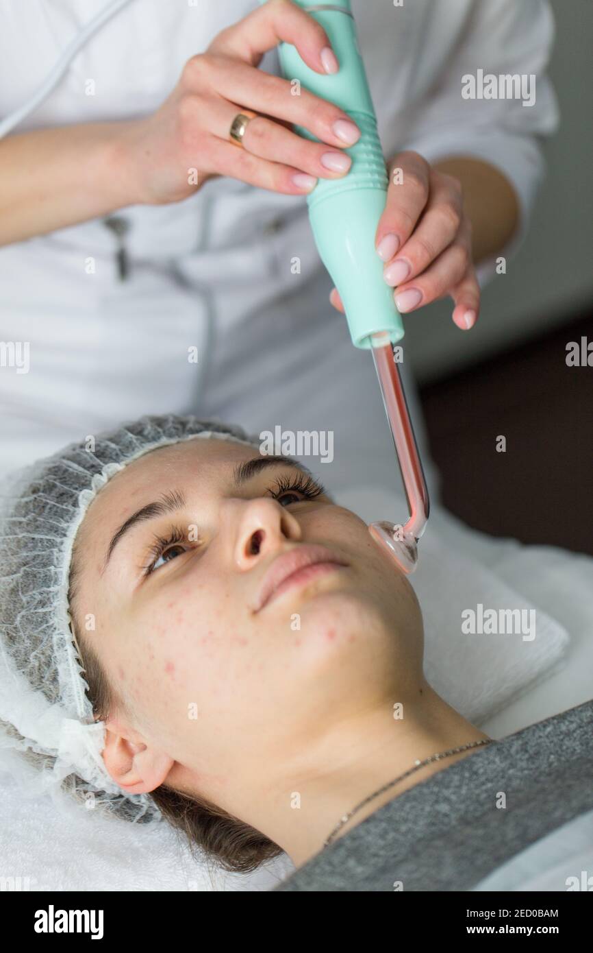 Violet ray treatment on face at the beautician. A violet ray is an ...