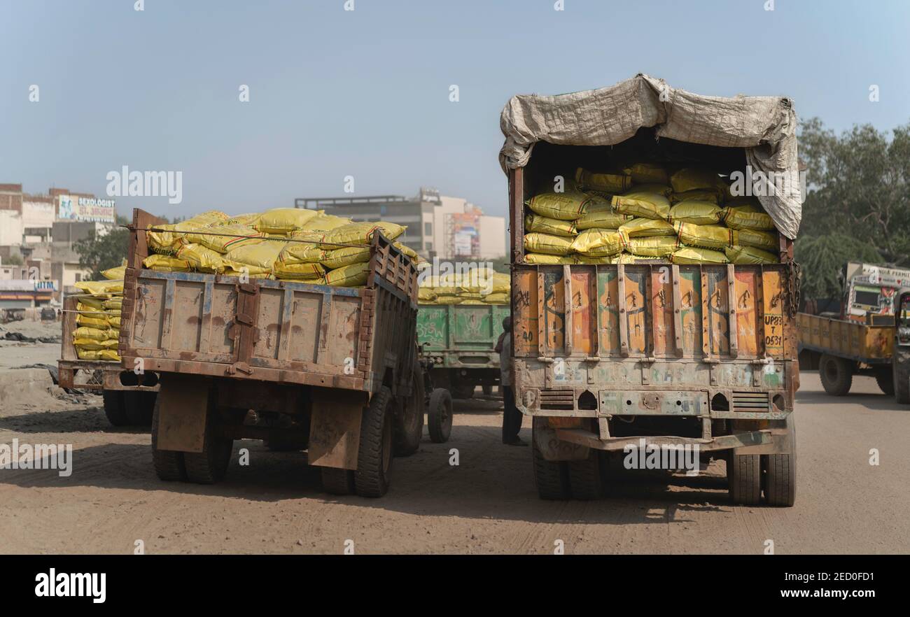 Manually loaded heavy bags of cement from train to waiting lorries in ...