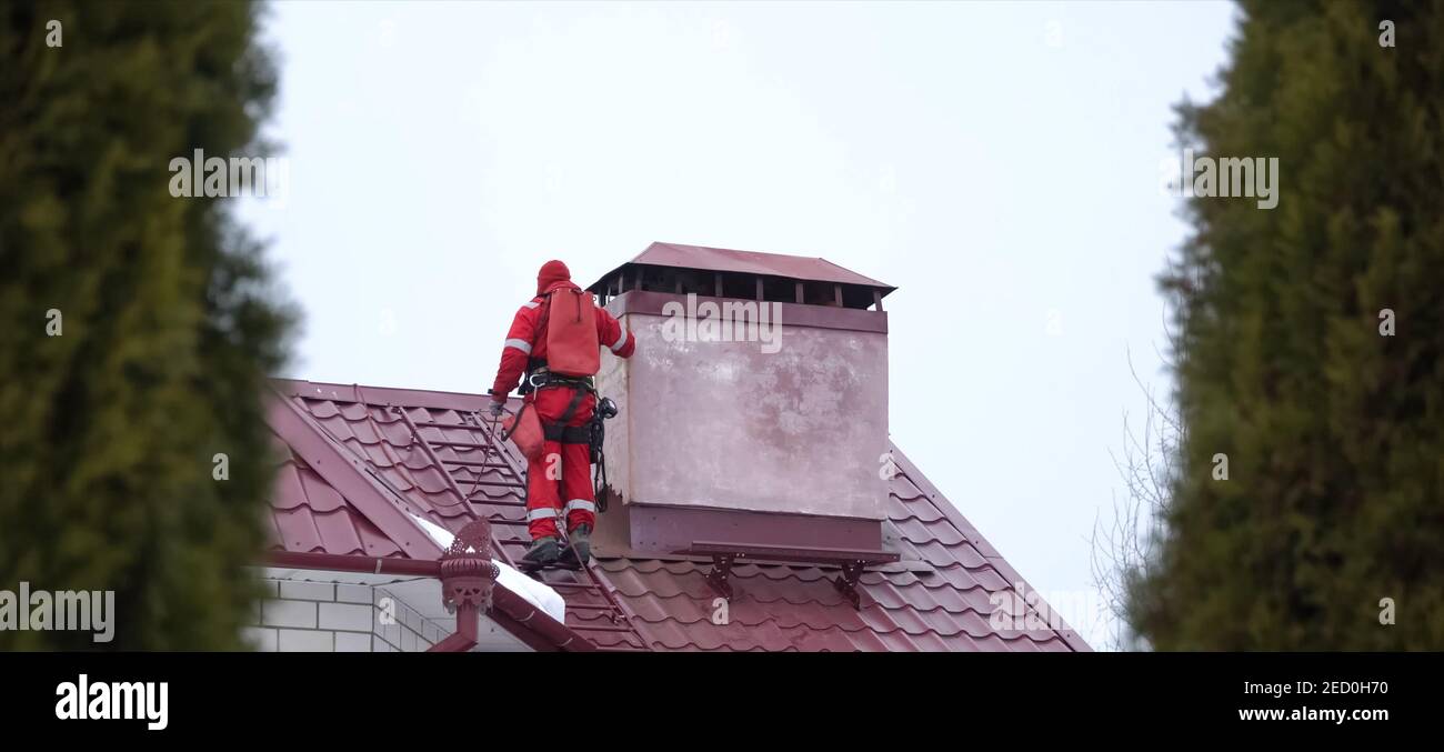 Worker does the installation of the roof of the house. Installation of ...