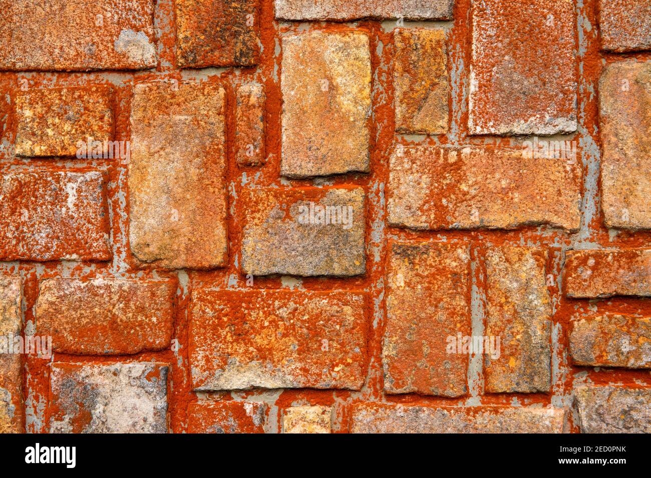 Rusty stone wall in orange and grey colors. Brickwork closeup photo for ...