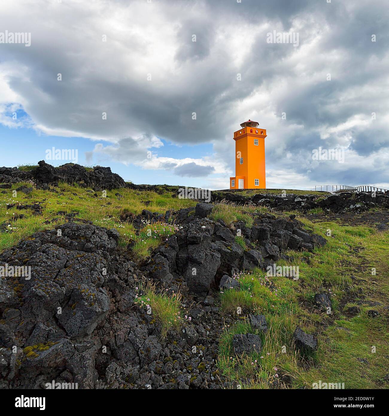 Orange lighthouse Skalasnagaviti or Svoertuloft at cliff, Oendveroarnes ...