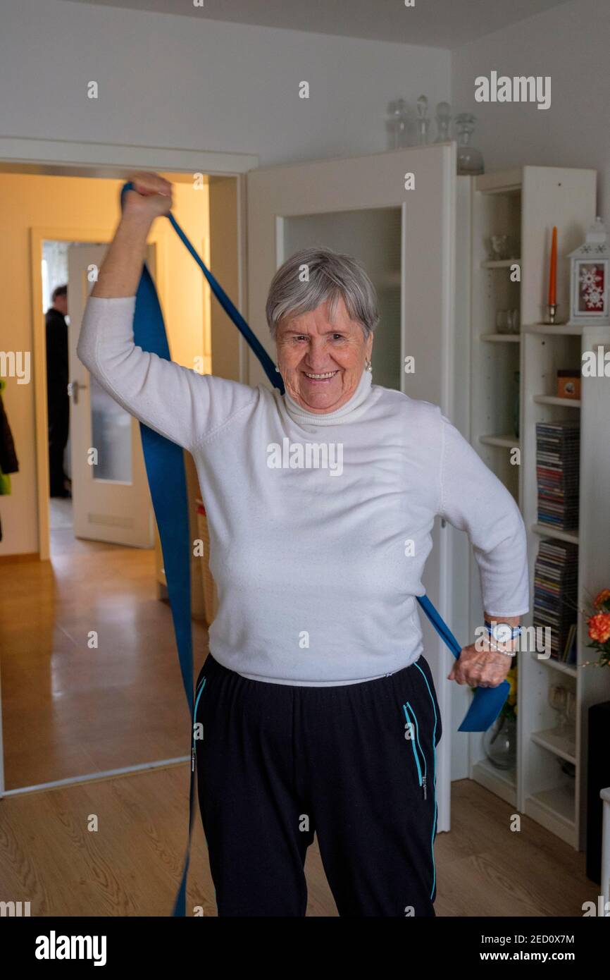 Senior, woman 87 years doing gymnastics at home, fitness in old age ...