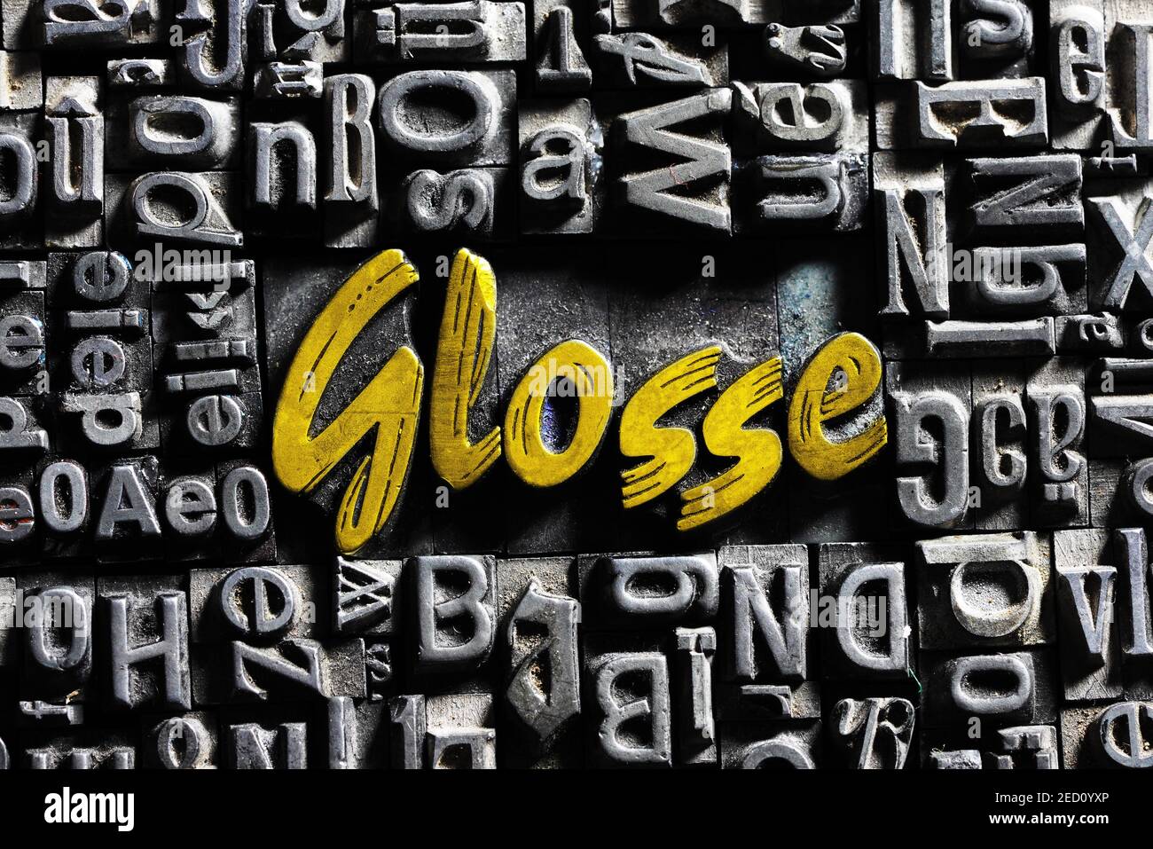 Old lead letters with golden writing, word gloss Stock Photo - Alamy