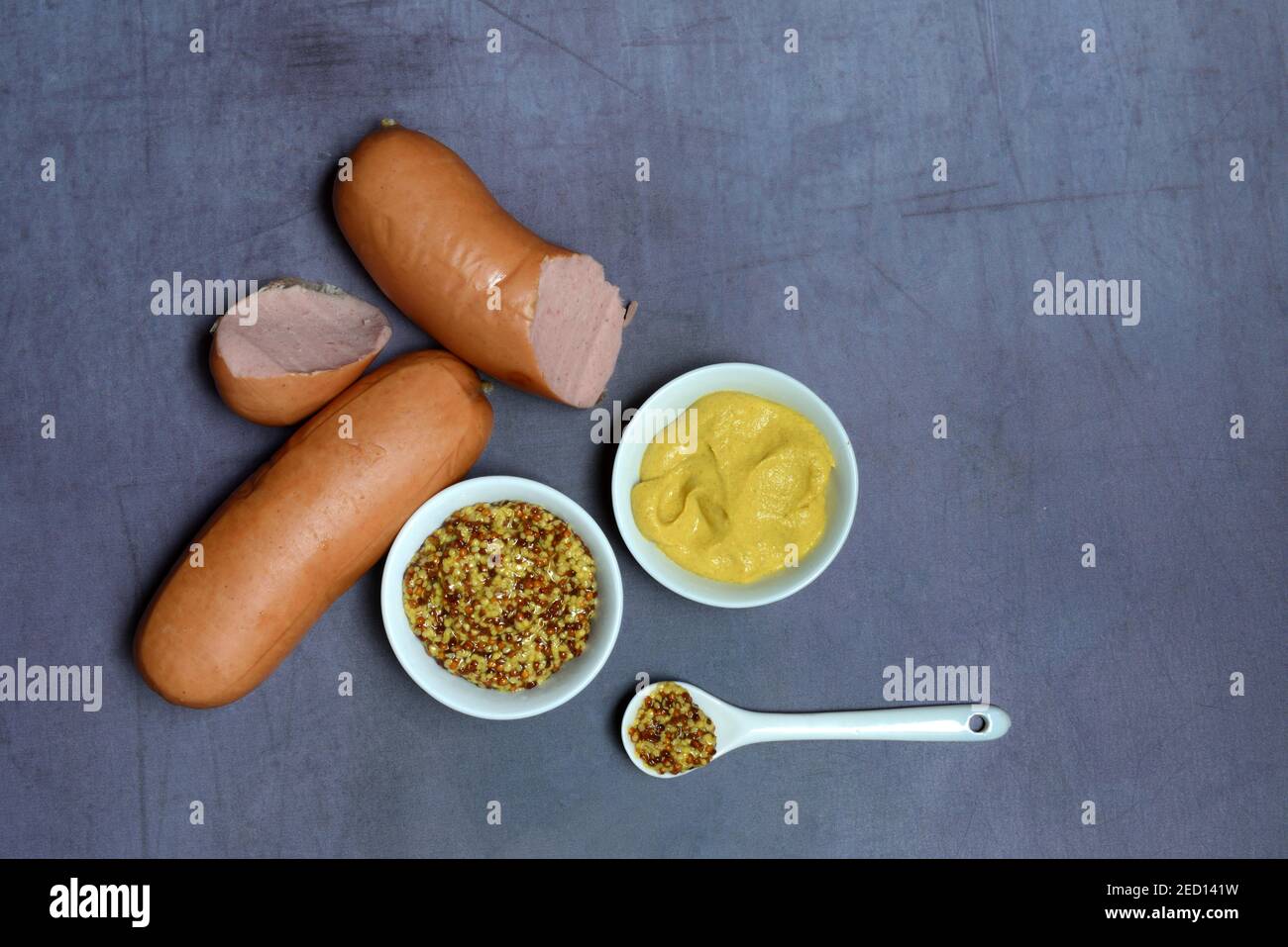 Mustard in trays and meat sausage, Germany Stock Photo - Alamy