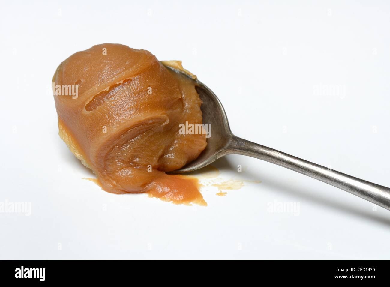 Salted caramel cream on spoon, white background, Germany Stock Photo ...