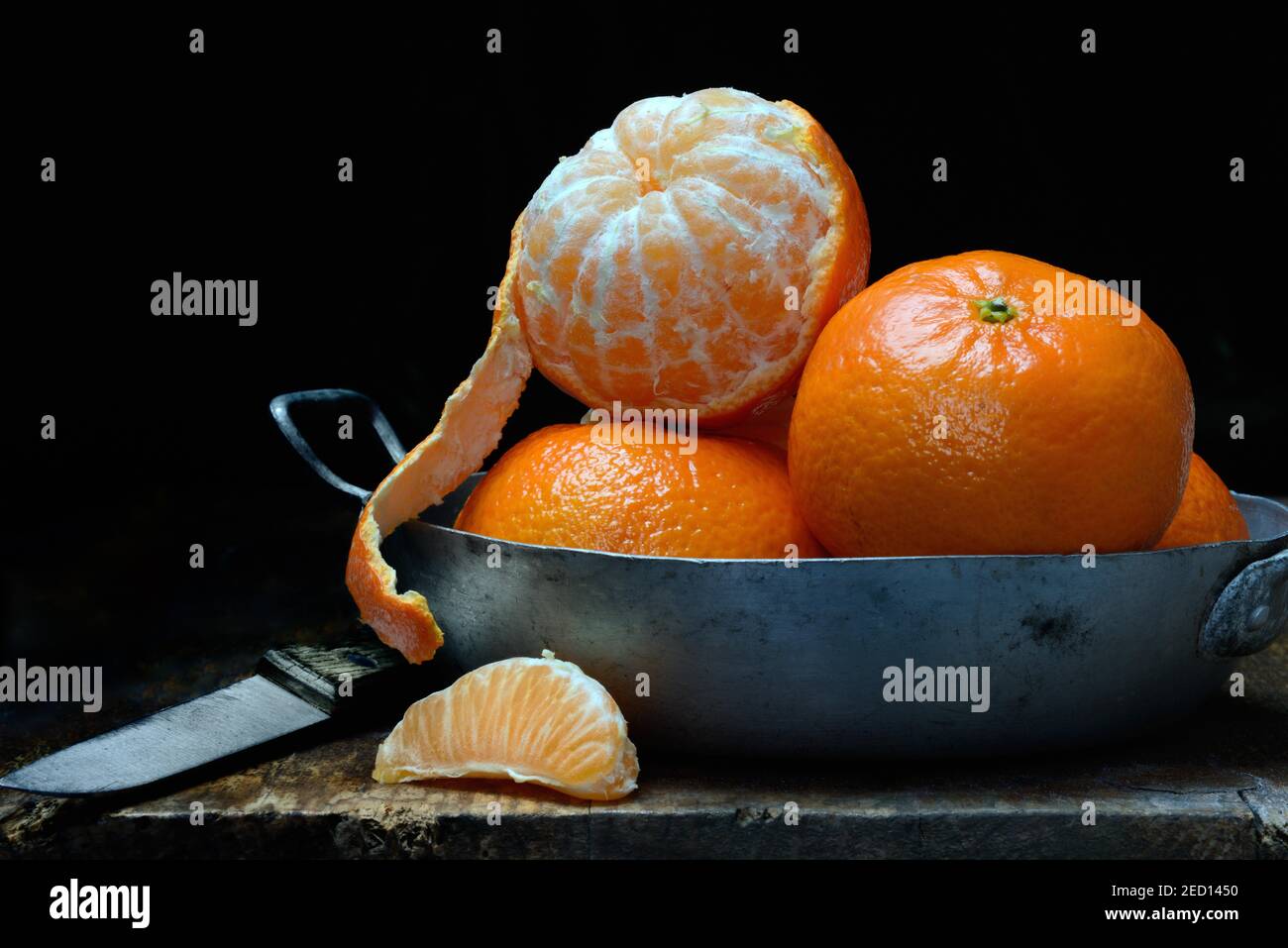 Unpeeled and half-peeled clementines in pan, Germany Stock Photo - Alamy