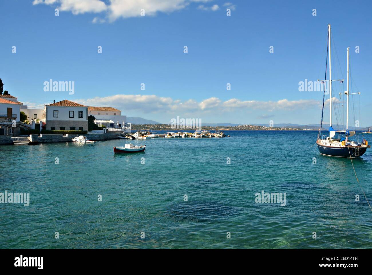 Seascape with view of a sailing boat at the port of Spetses island in ...