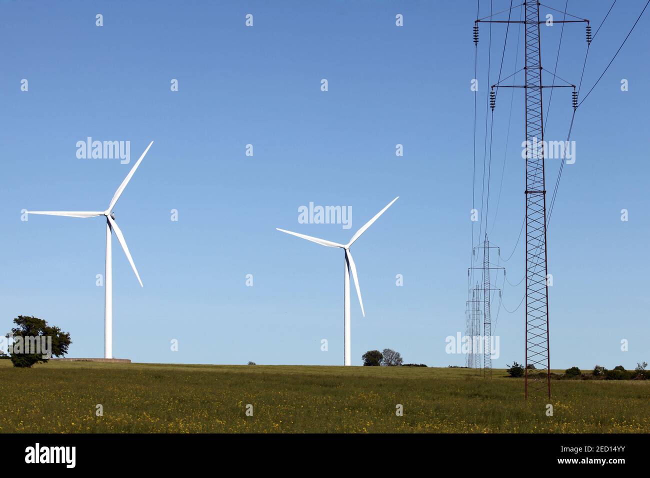 Two wind turbines and high voltage power line Stock Photo - Alamy