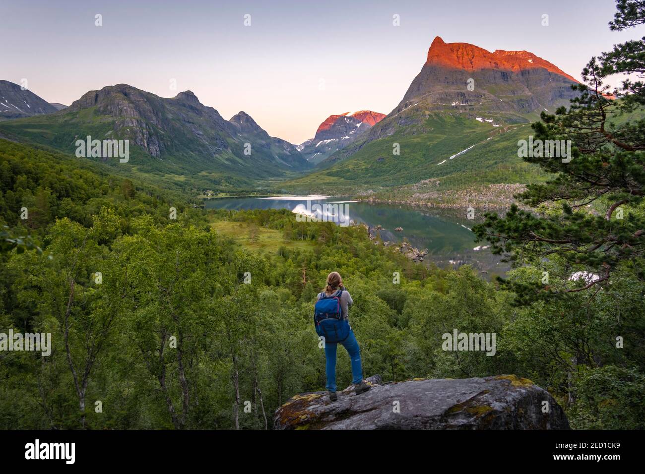 Sunset, hiker looking over lake, evening mood at lake Innerdalsvatna ...