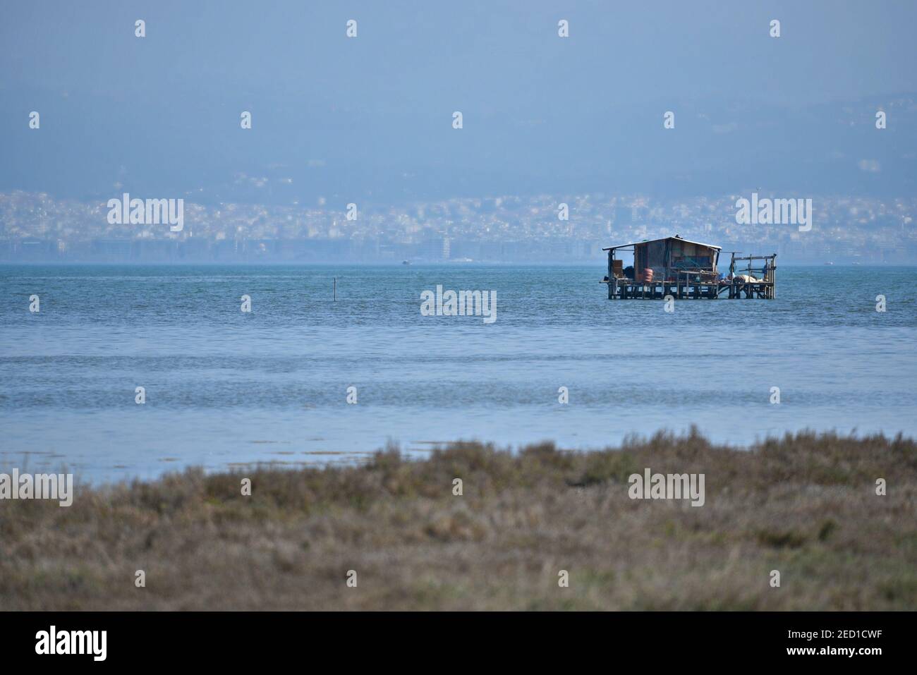 Landscape with a traditional Greek fisherman's shack on the waters of ...