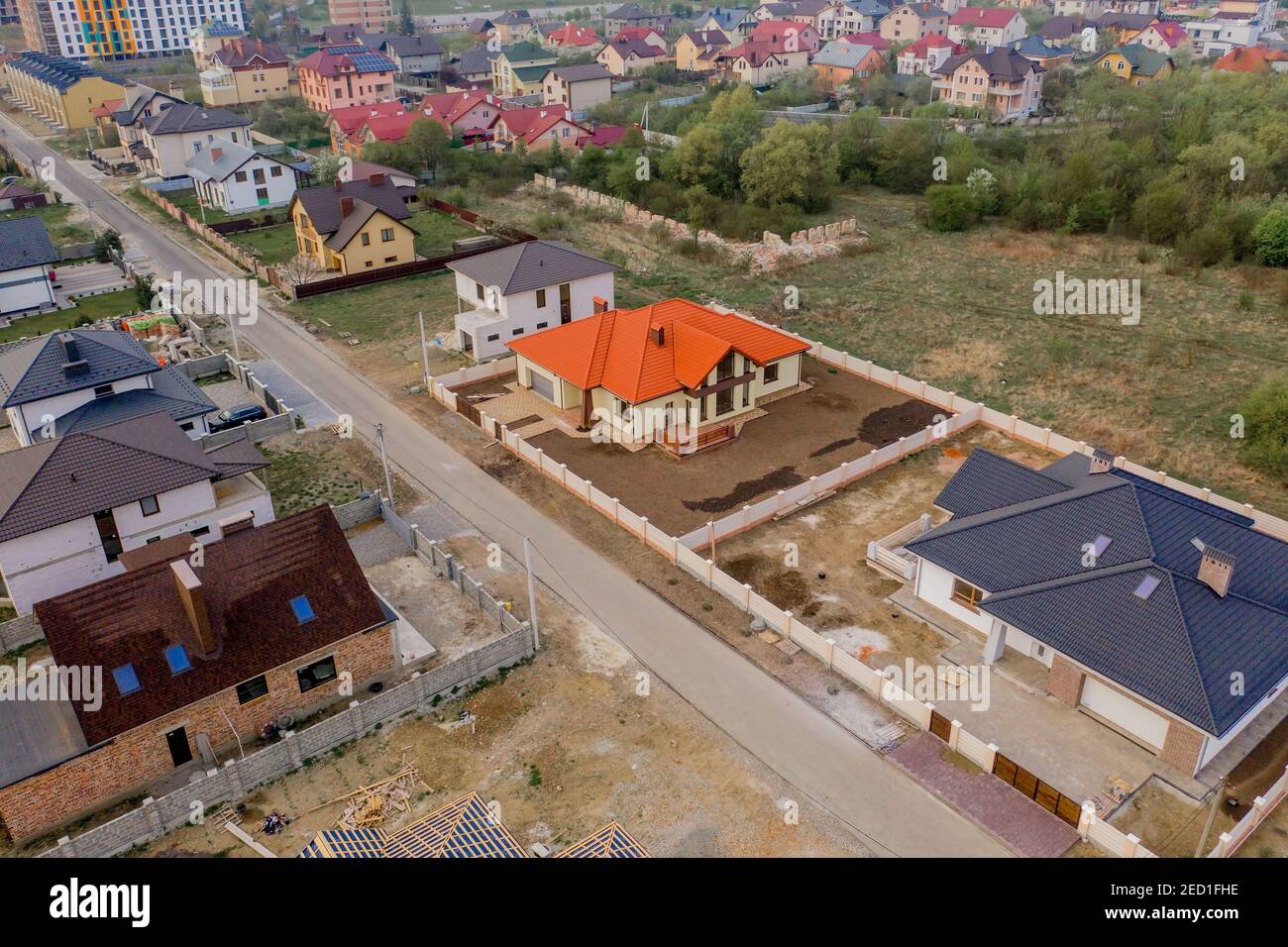 Aerial top view of a house with paved yard with green grass lawn with ...