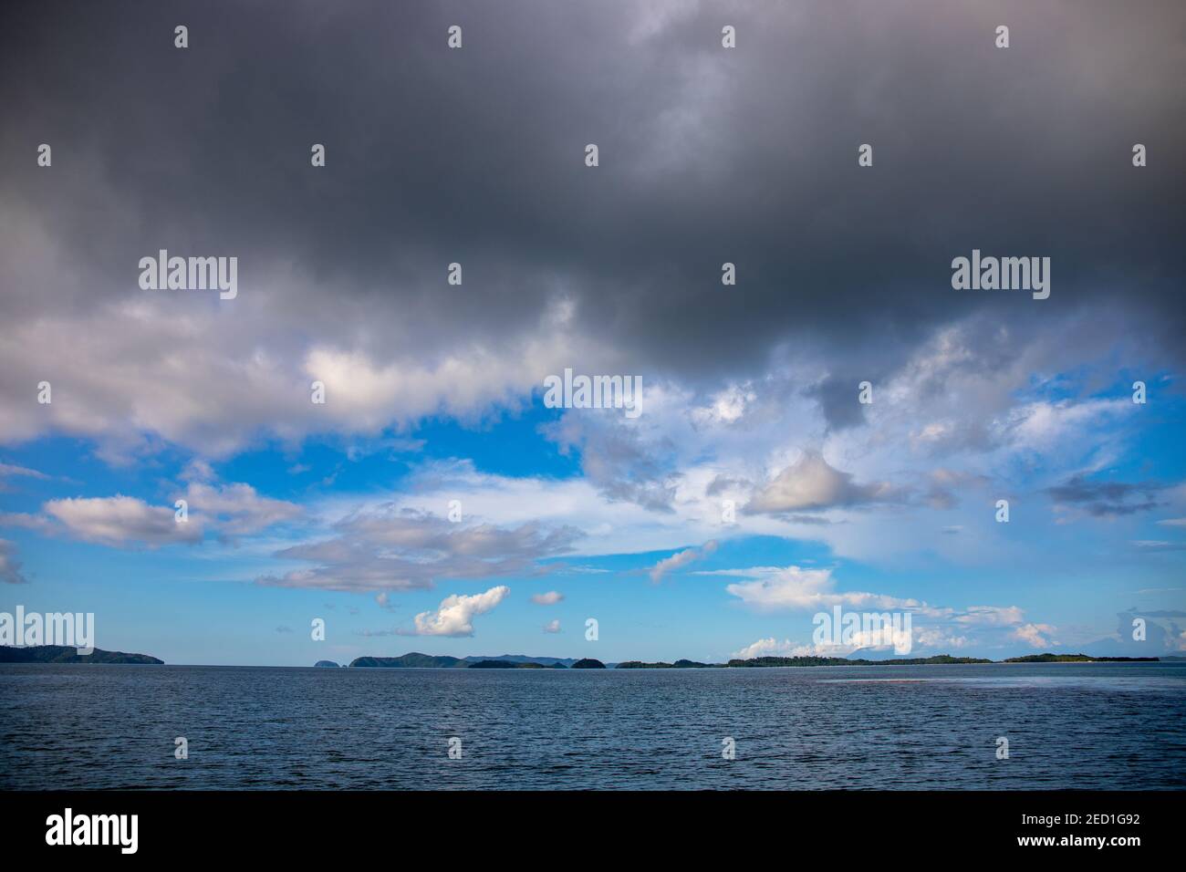 Rain clouds on blue sky and still sea. Palawan island seascape. Rain ...