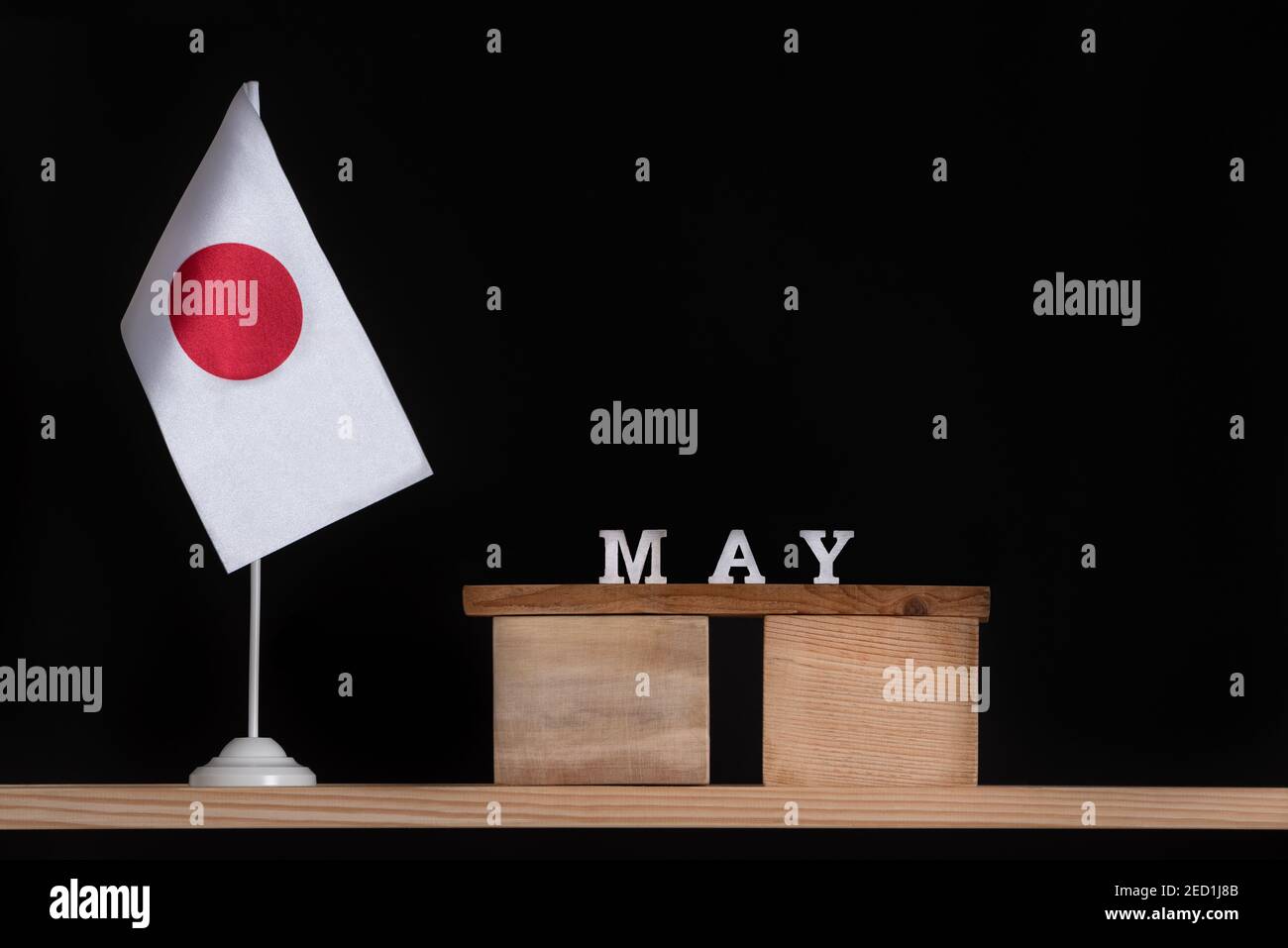 Wooden calendar of May with table Japanese flag on black background ...