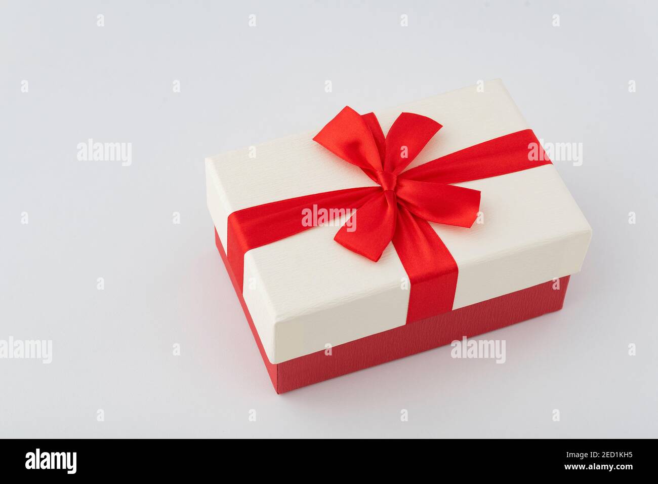 White box with red ribbon on white background. Gift wrap Stock Photo ...